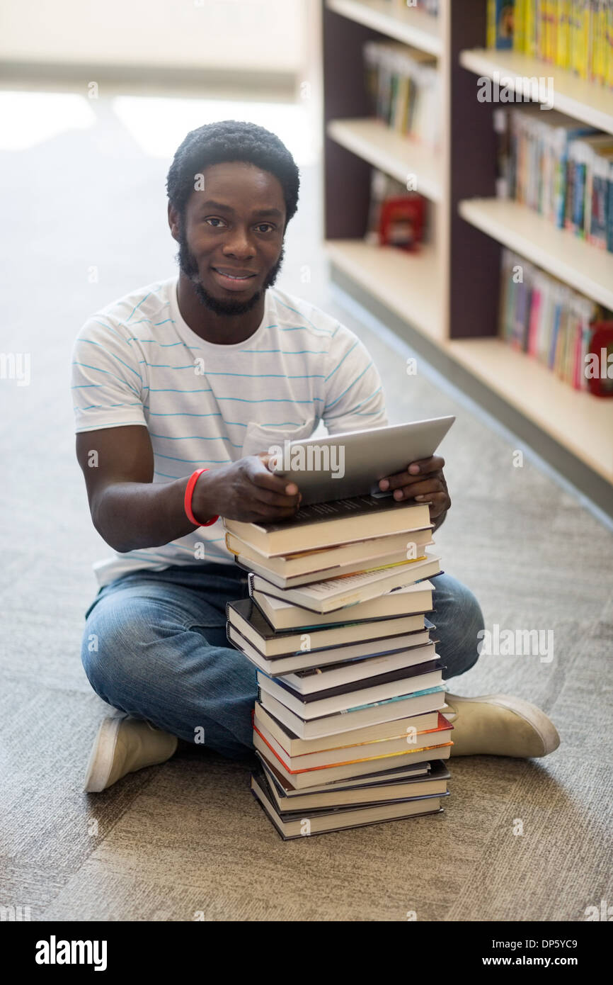 Student With Books And Digital Tablet Sitting In Library Stock Photo ...