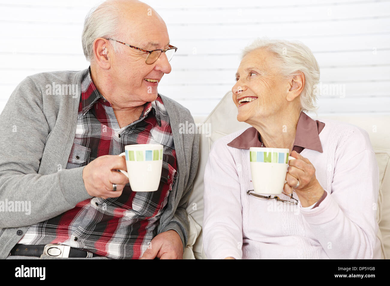 Happy senior citizen couple drinking coffee together Stock Photo - Alamy