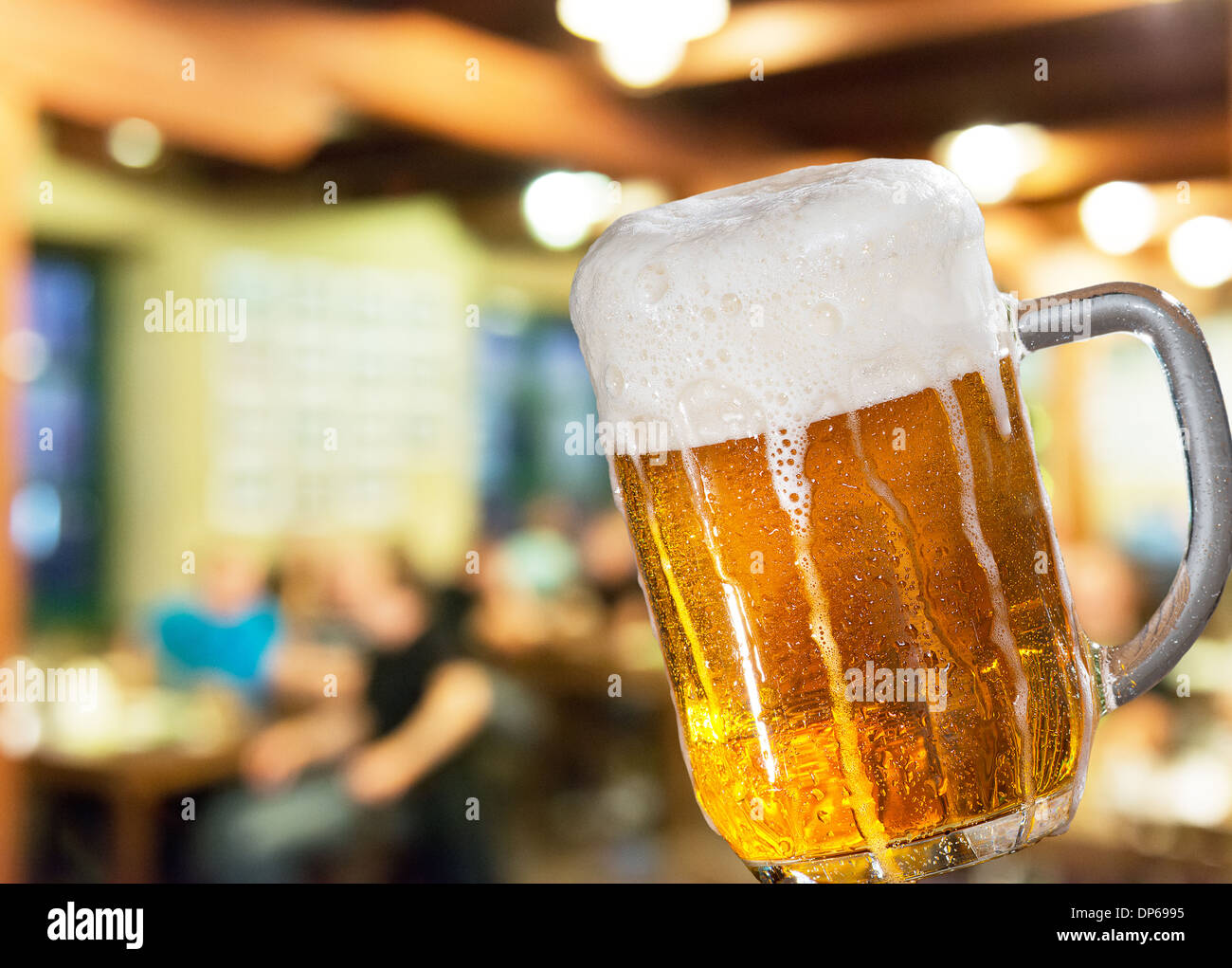 glass of beer in the pug with unfocused background Stock Photo - Alamy
