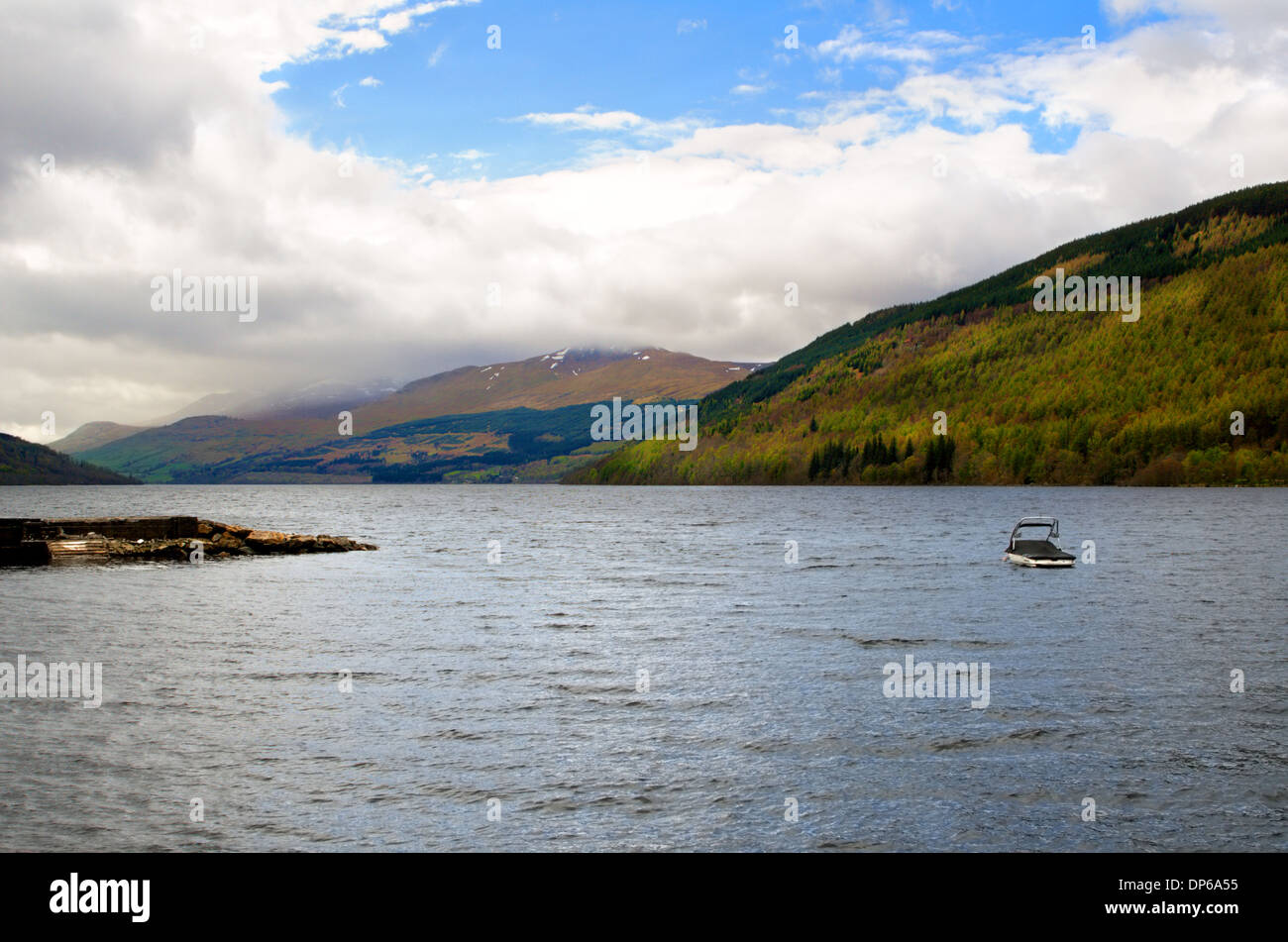 Loch side view with blue sky and dramatic clouds Stock Photo - Alamy