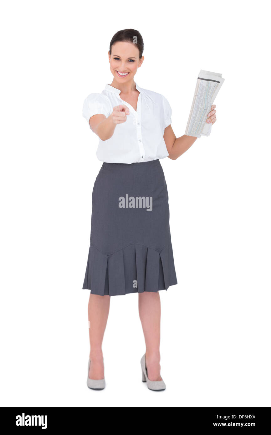 Stylish businesswoman pointing while holding newspaper Stock Photo - Alamy