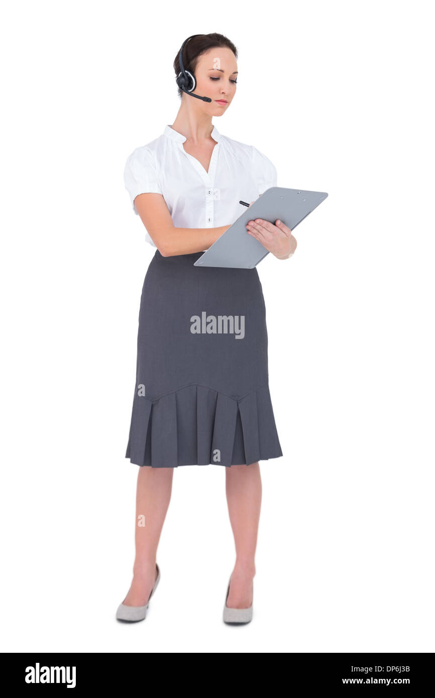 Focused call center agent holding clipboard Stock Photo - Alamy
