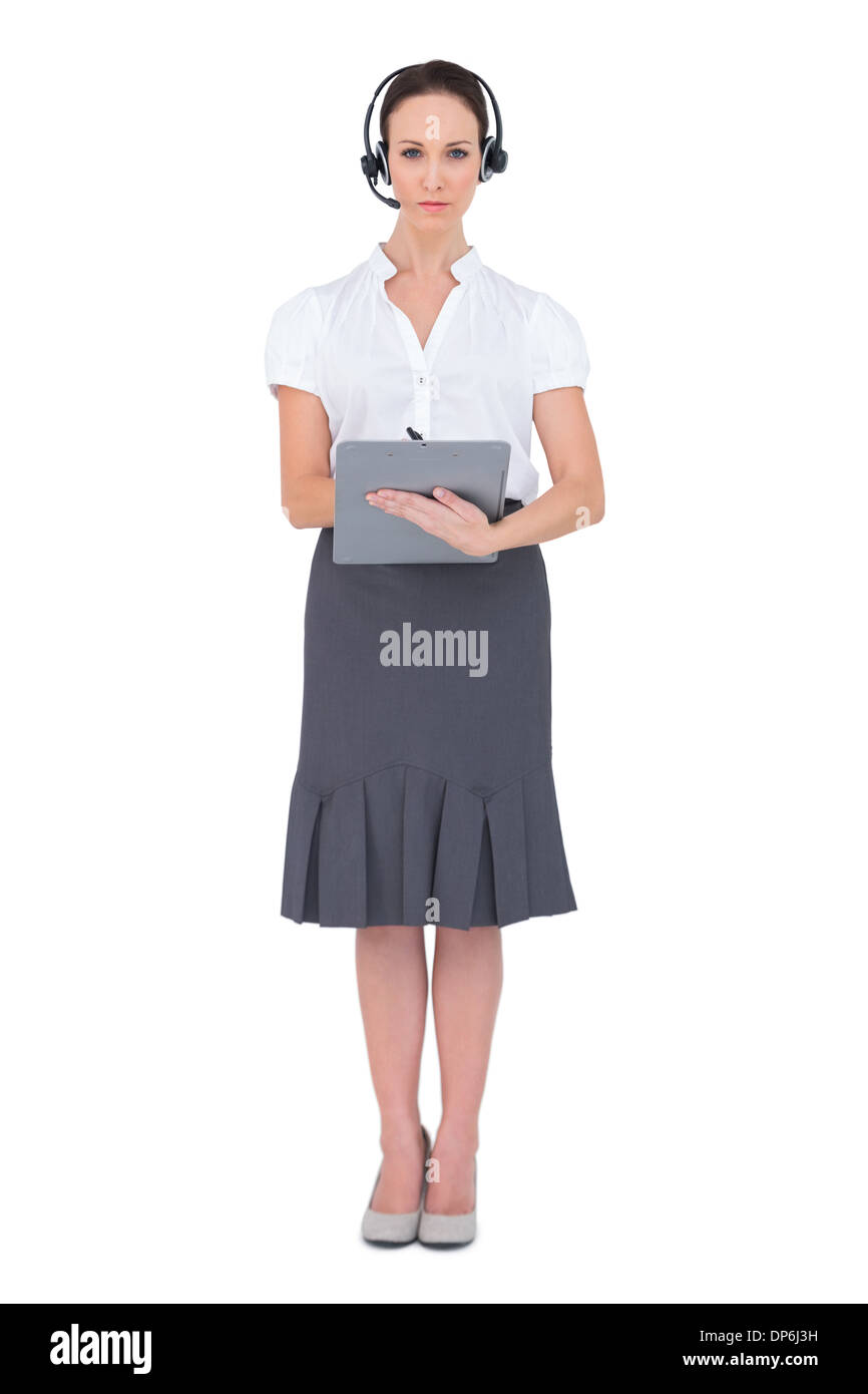 Serious call center agent holding clipboard Stock Photo - Alamy
