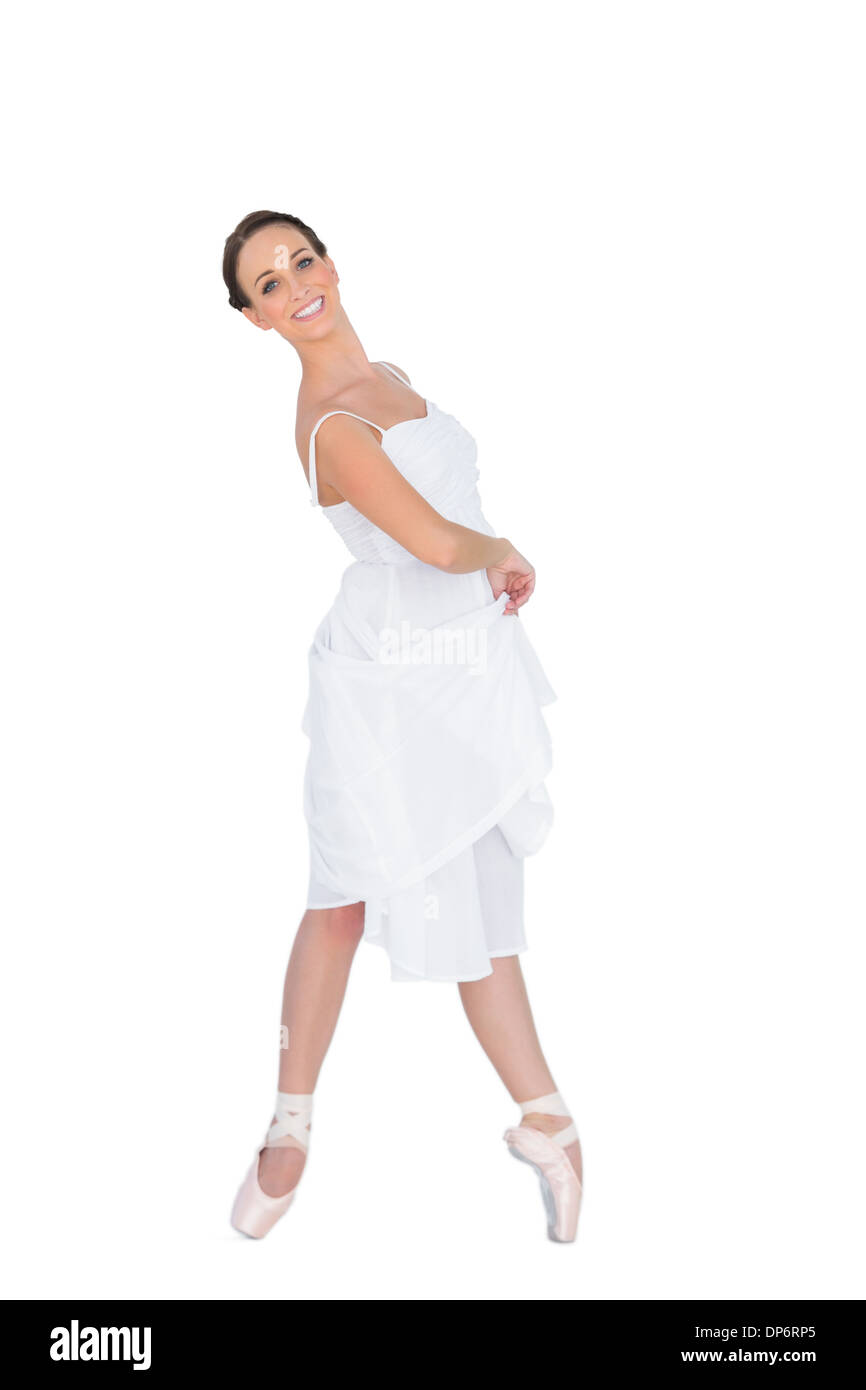 Smiling young ballet dancer standing on her tiptoes Stock Photo - Alamy
