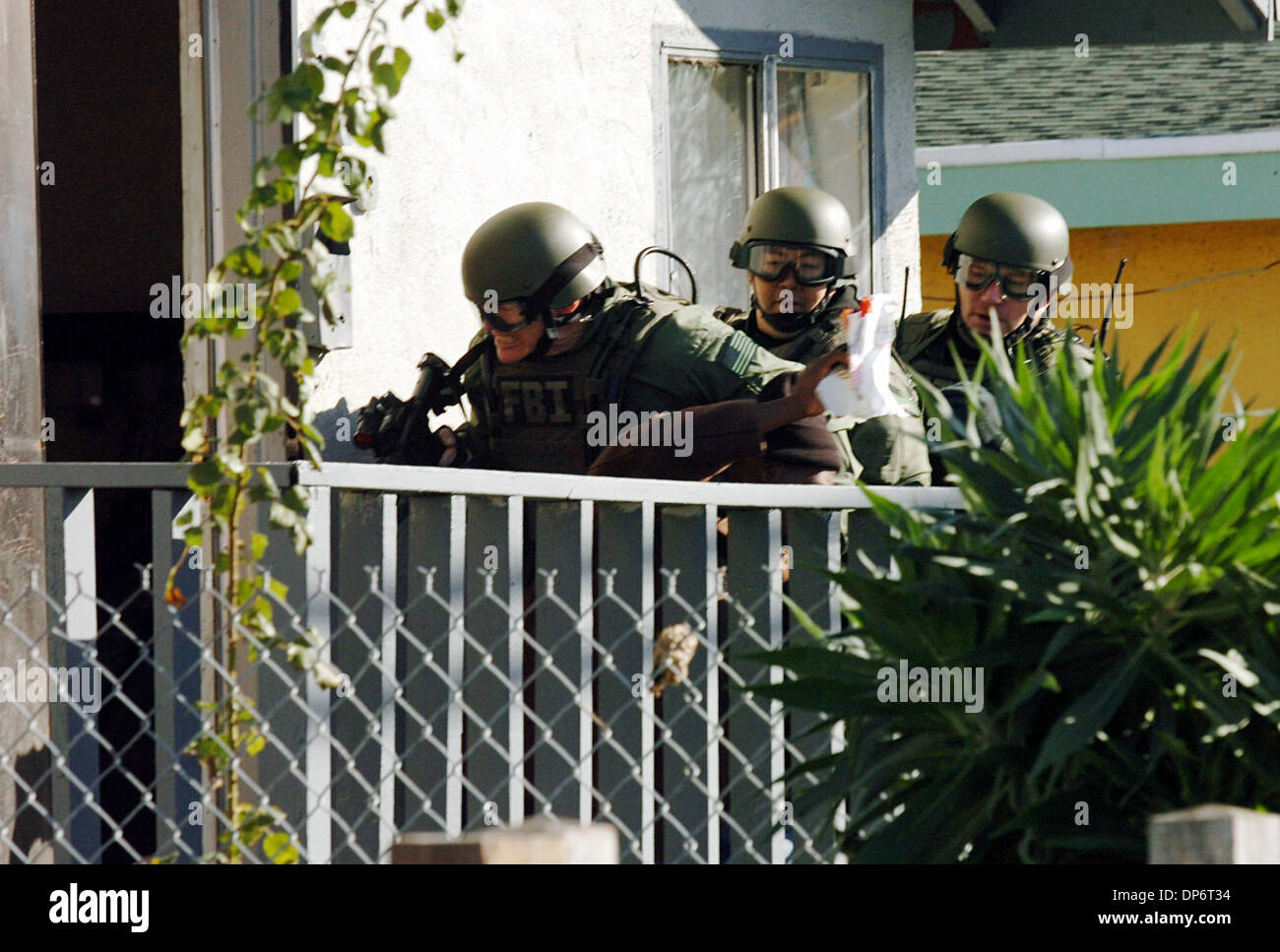 Oct 25, 2006; North Richmond, CA, USA; An FBI SWAT team forcibly enters ...