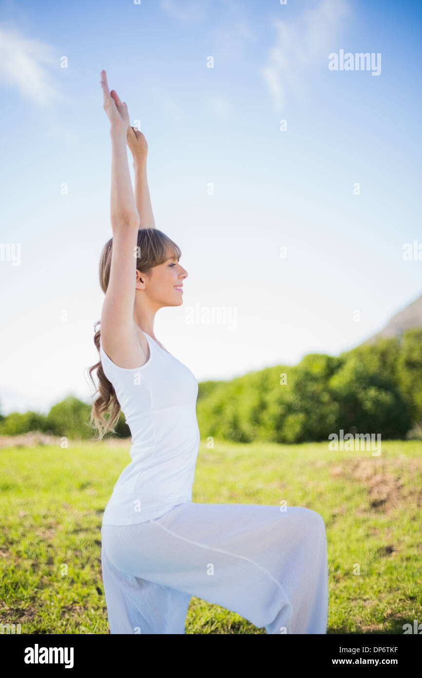 Cheerful young woman stretching outside Stock Photo - Alamy