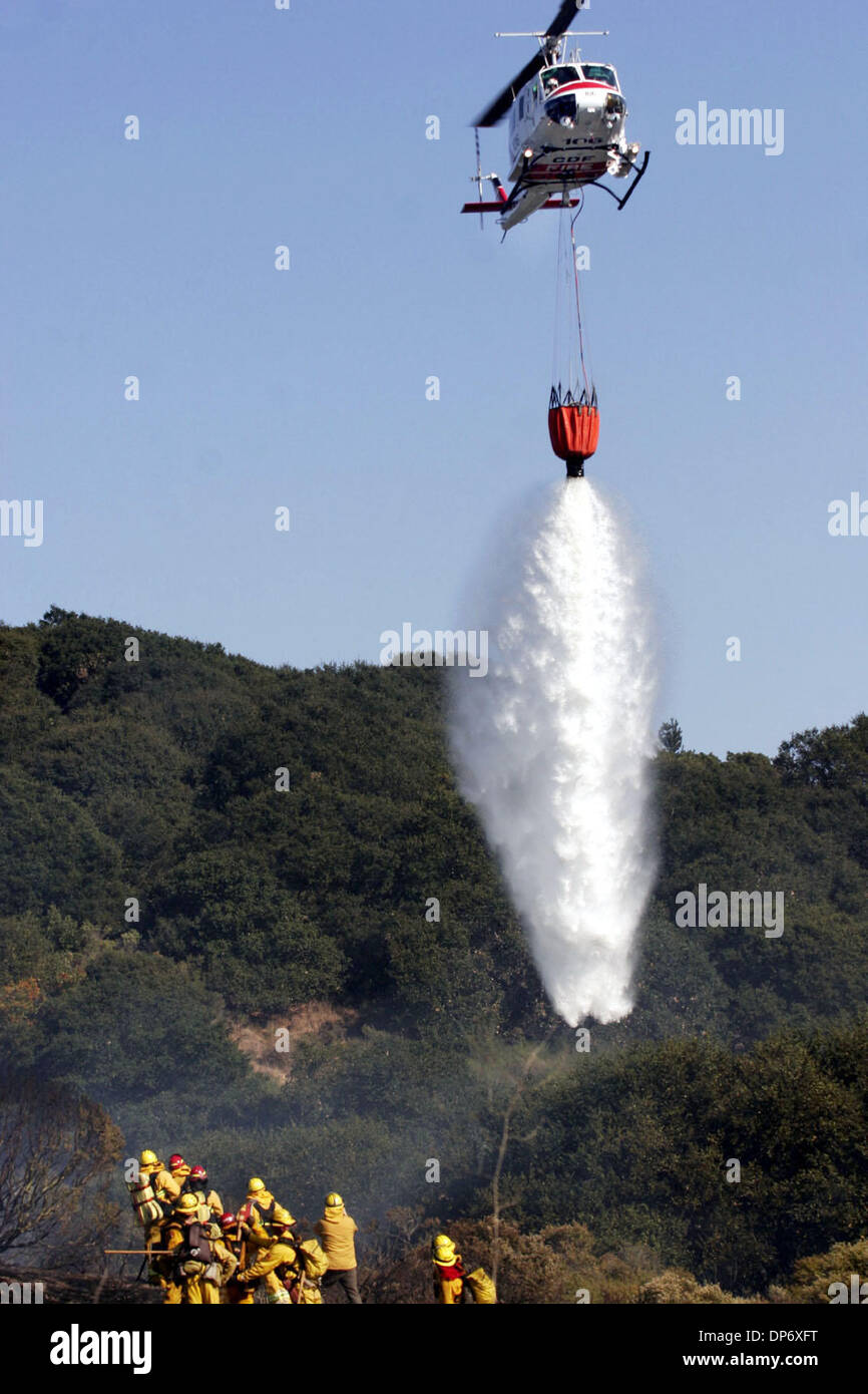 Oct 27, 2006; Richmond, CALIFORNIA, USA; A CDF helicopter drops water ...
