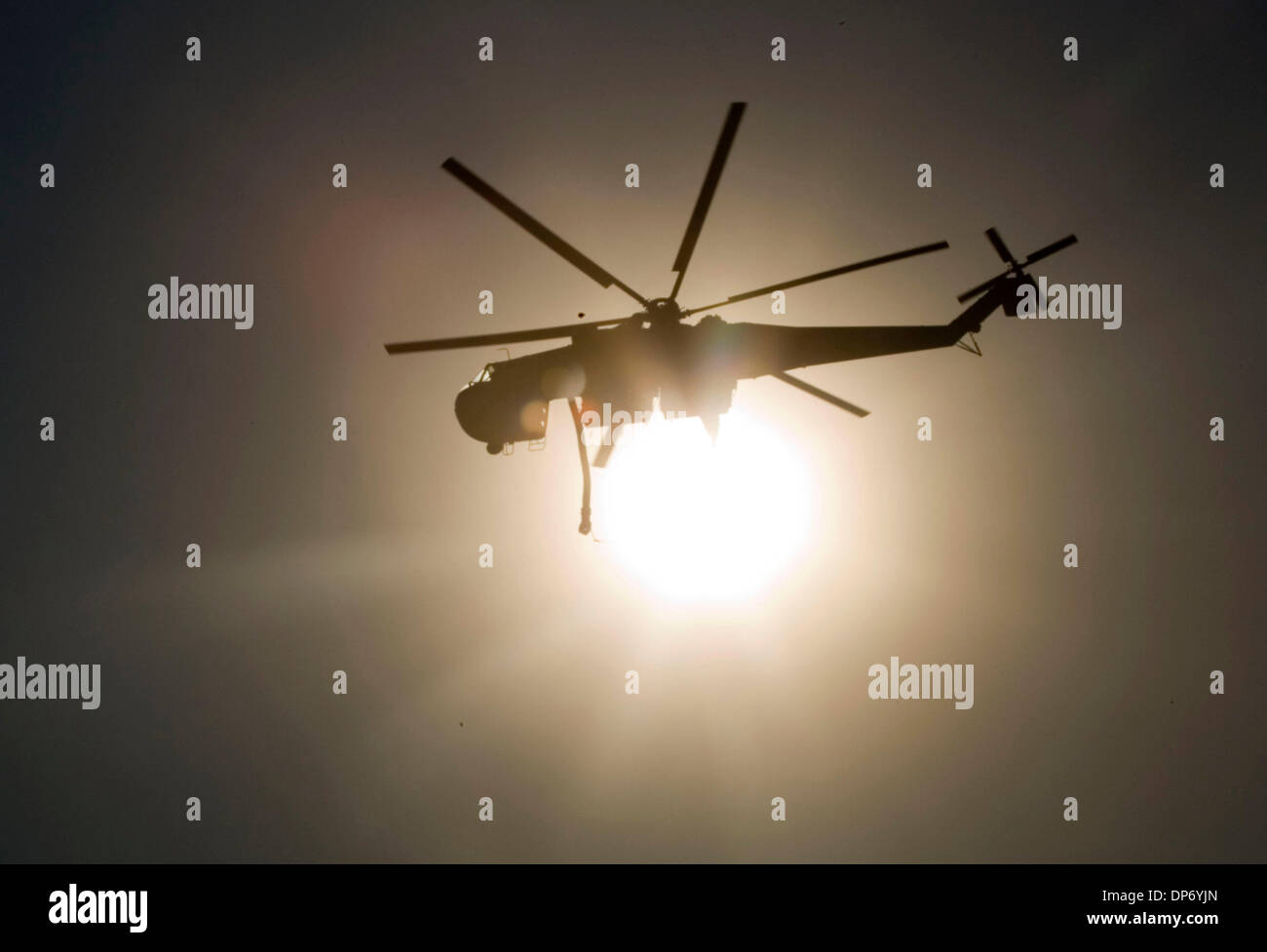 Oct 28, 2006; Riverside, CA, USA; A helicopter water tanker flies over ...