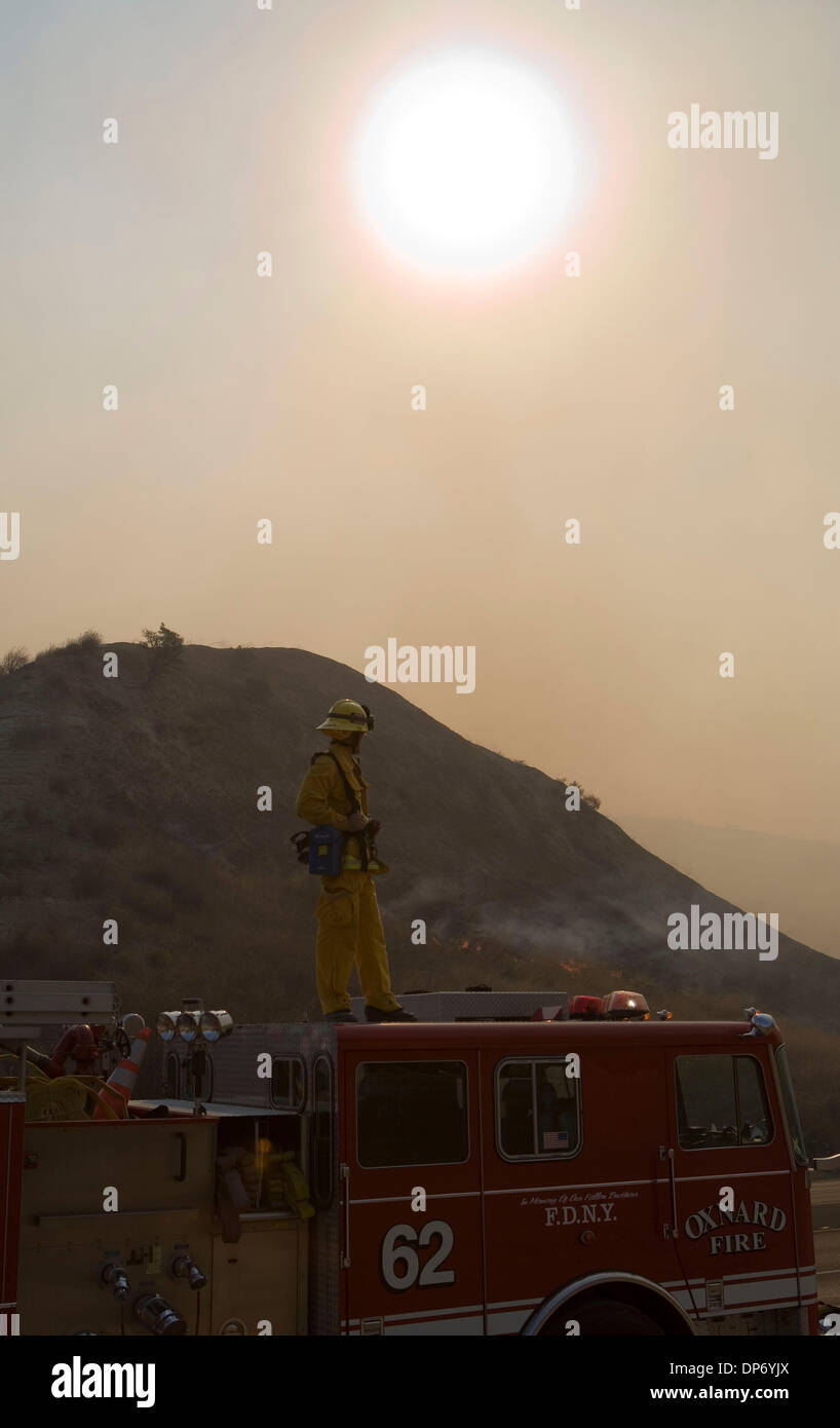 Oct 28, 2006; Riverside, CA, USA; A firefighter stands on top of his ...