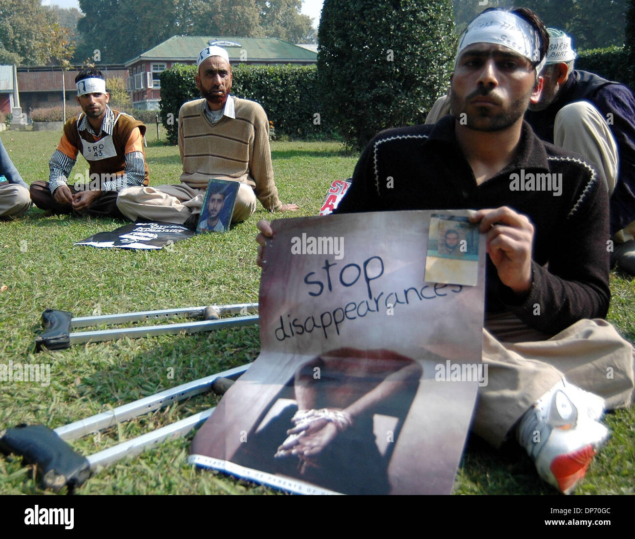 Oct 30, 2006; Srinagar, Kashmir, INDIA; Kashmiri men hold photographs ...