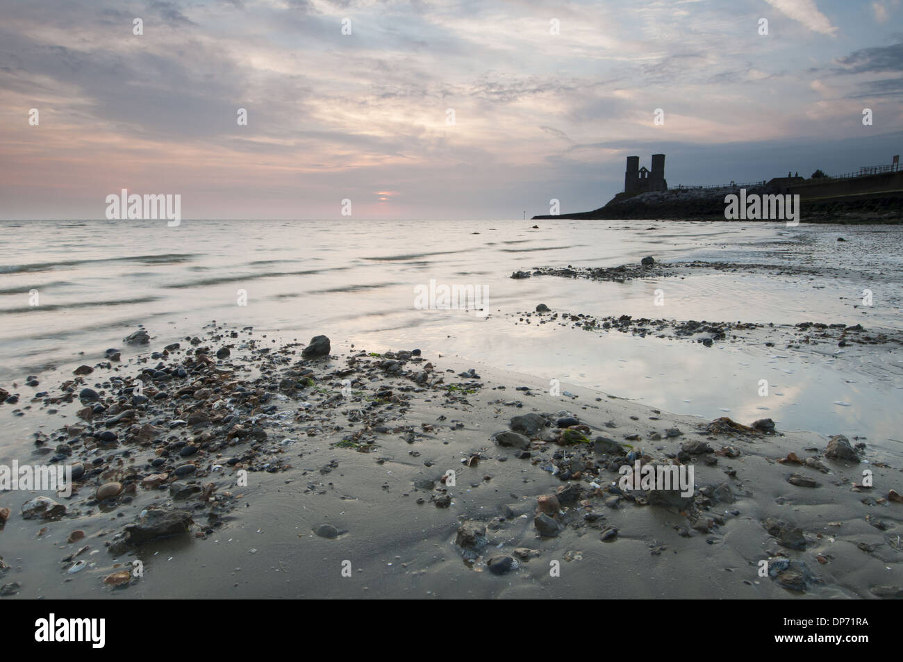 View of beach at low tide with 12th Century ruined church in distance ...