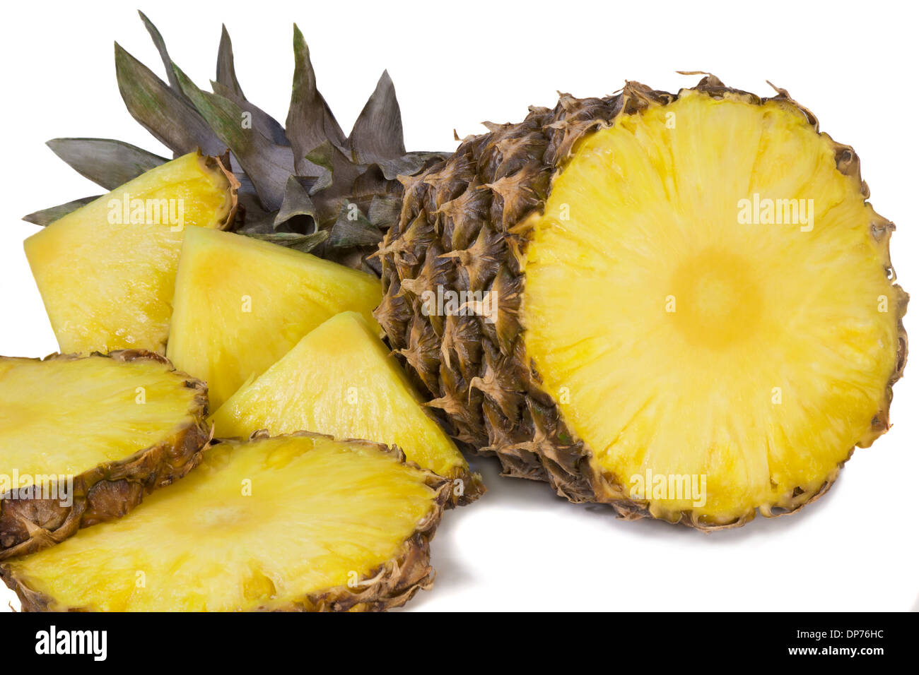 Sliced pineapple and slices of pineapple. Photographed on a white ...
