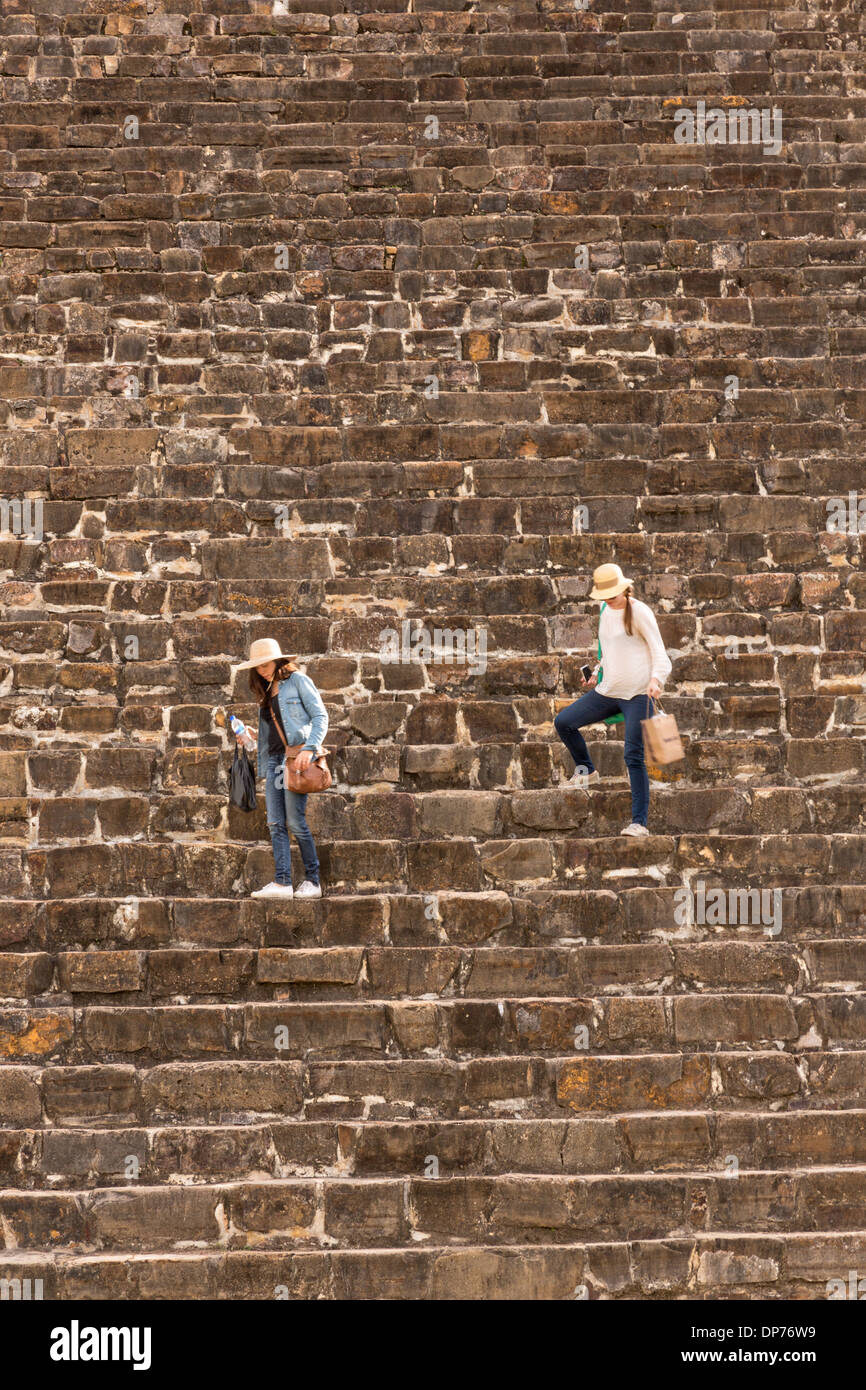Tourists walks down the steps of the south platform of Monte Albán pre ...