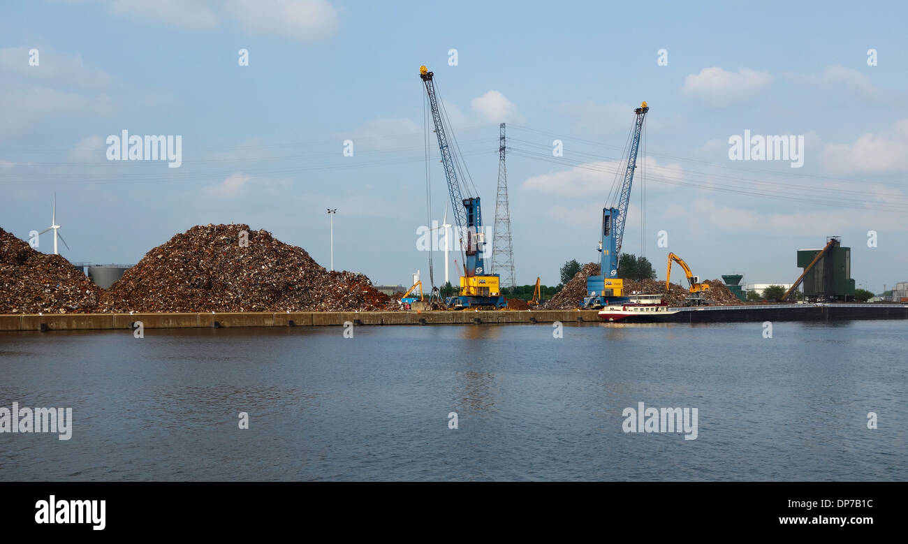 Dock cranes and heaps of scrap metal at Van Heyghen Recycling export ...