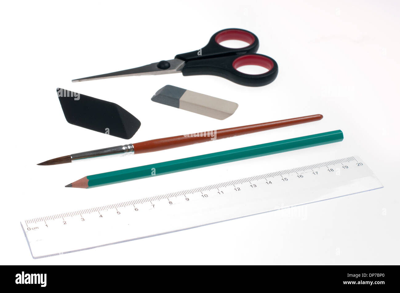 Stationery- rubber, ruler, pencil, scissors, brush- on a white ...