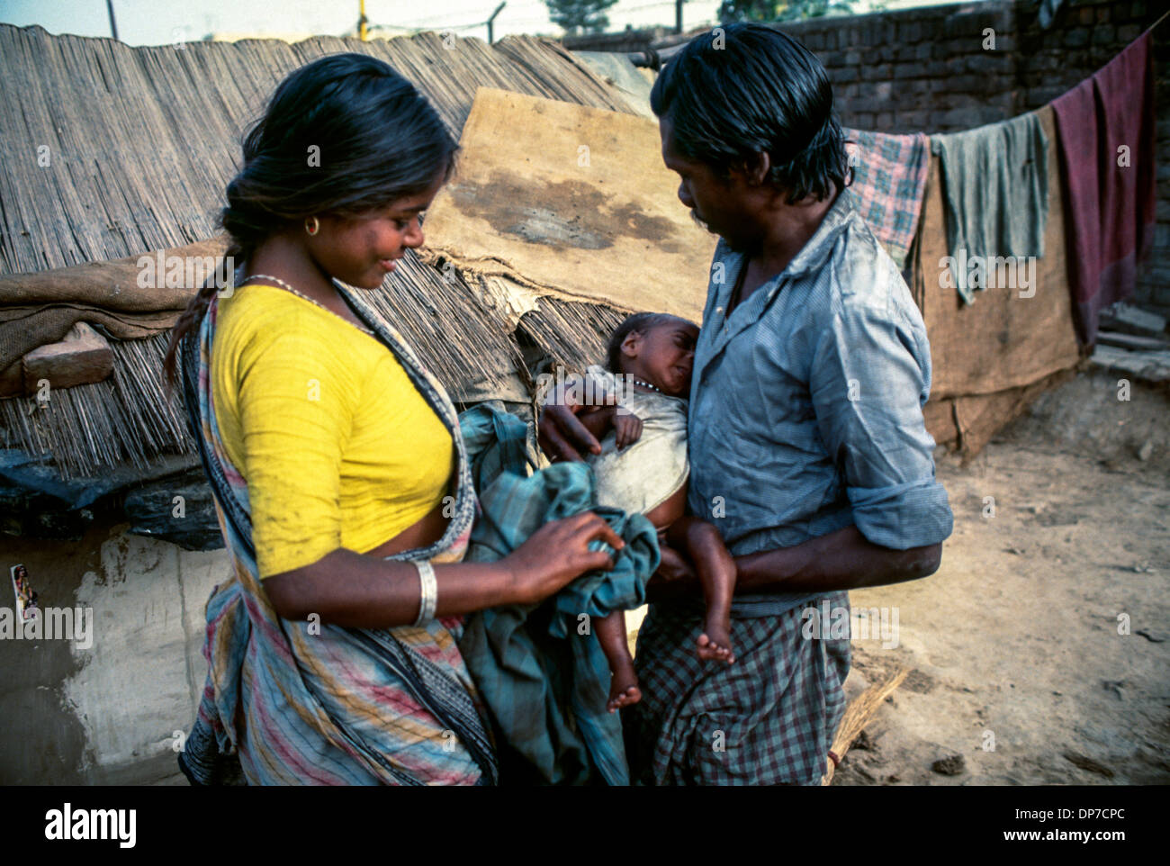 Young Indian couple of low caste living in a shanty town & working on a ...