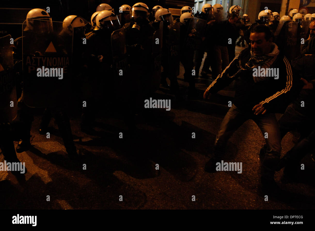 Athens, Greece. 8th Jan, 2014. Greek riot policemen use pepper spray to ...