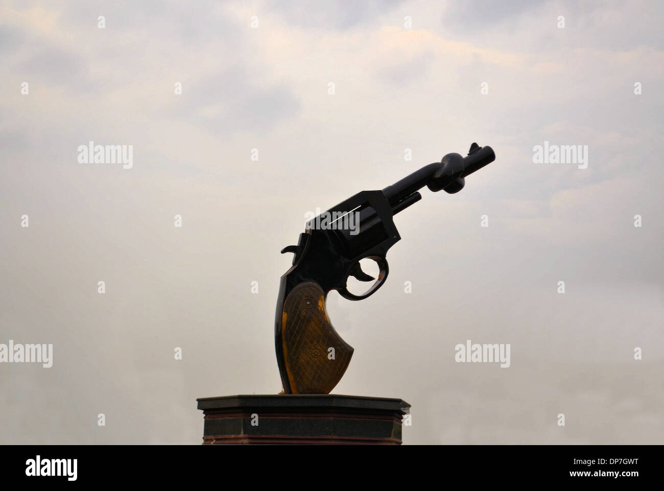 the monument of a huge handgun, which muzzle was bend Stock Photo - Alamy
