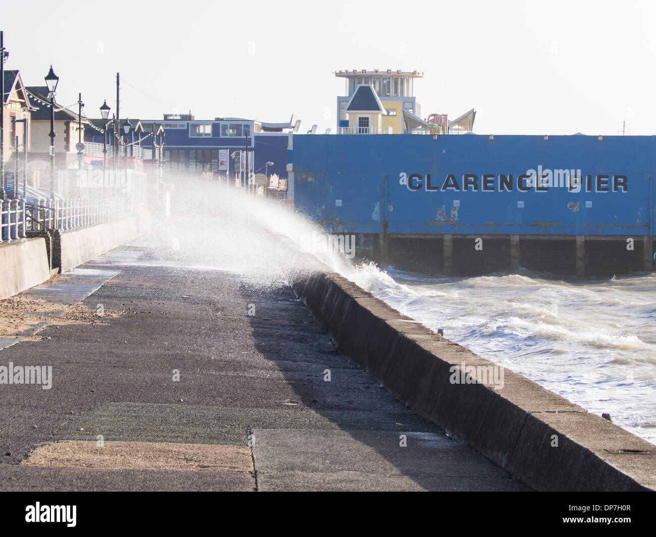 Waves from the Solent breaking over the sea wall beside Clarence Pier ...