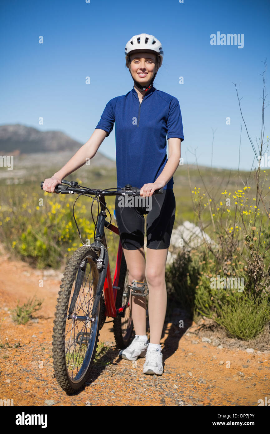 Woman standing and holding bike Stock Photo - Alamy