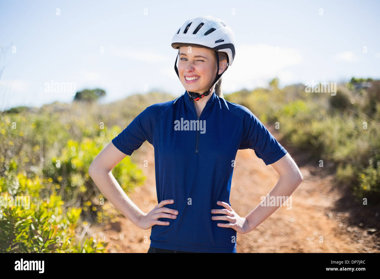 Woman with hands on hips wearing helmet Stock Photo - Alamy
