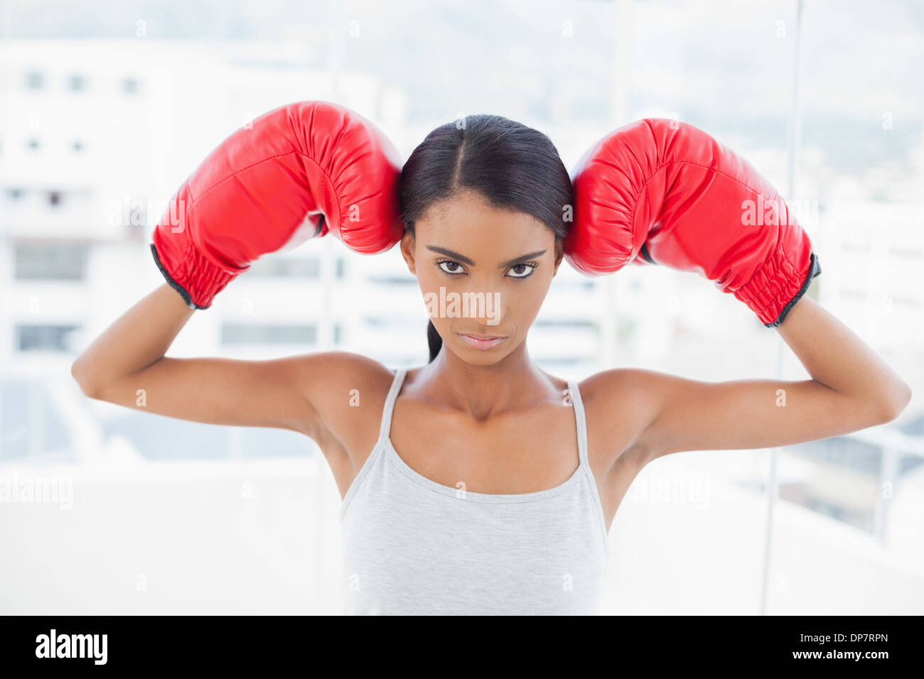 Serious competitive model wearing red boxing gloves Stock Photo - Alamy