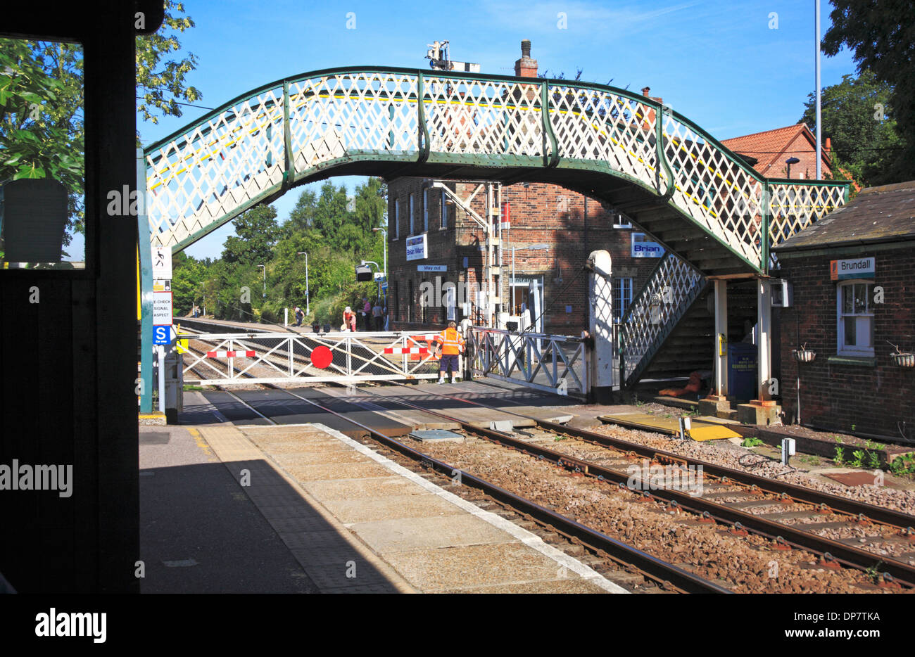 A view of the railway station with pedestrian bridge and level crossing ...