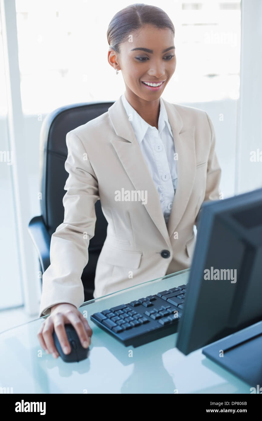 Cheerful attractive businesswoman working on her computer Stock Photo ...