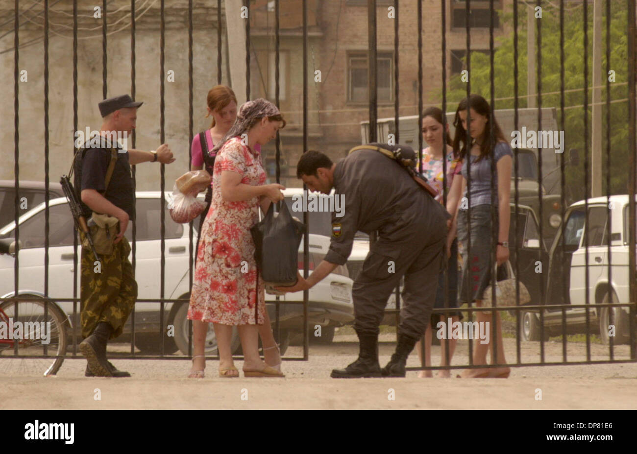 Chechen police forces officer is doing a search of a chechen woman in ...