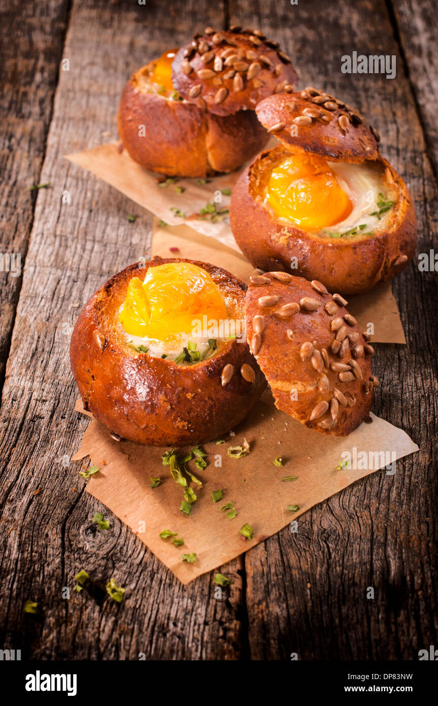 Baked eggs in the whole grain buns.Selective focus on the front bun ...