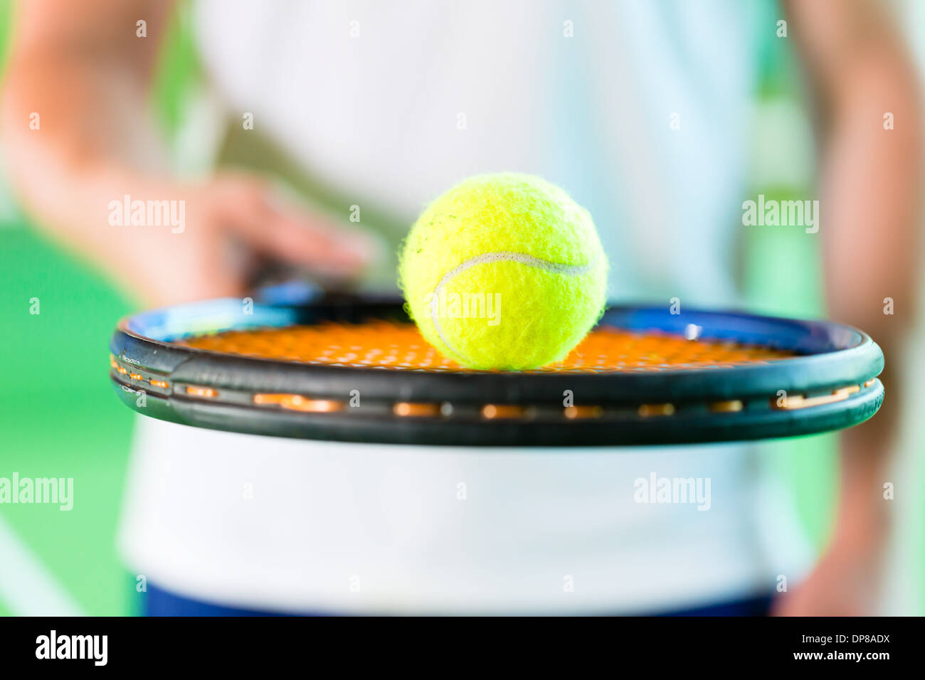 Woman playing tennis, only upper body with racket and ball, giving ...