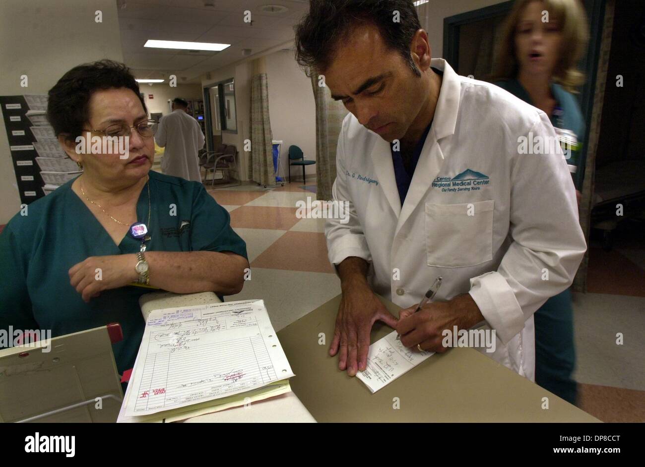 (Published 8/1/2004, A-16, UTS1822926) Dr. George Rodriguez signs ...