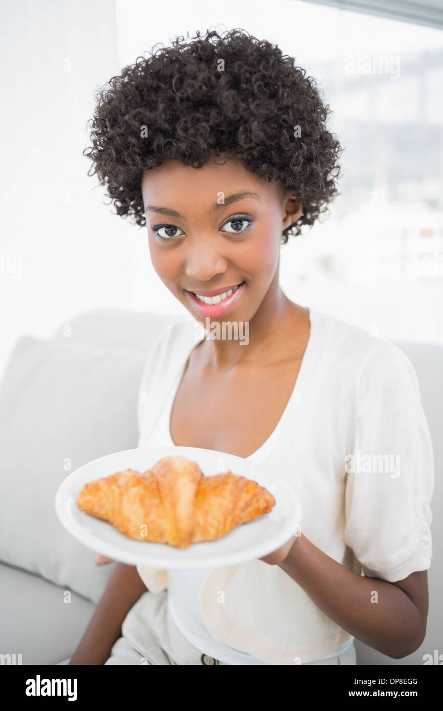 Happy gorgeous brunette having croissant for breakfast Stock Photo - Alamy