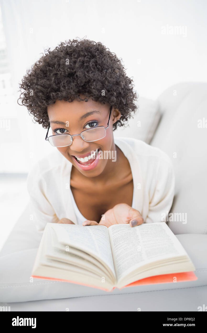 Smiling afro woman reading hi-res stock photography and images - Alamy
