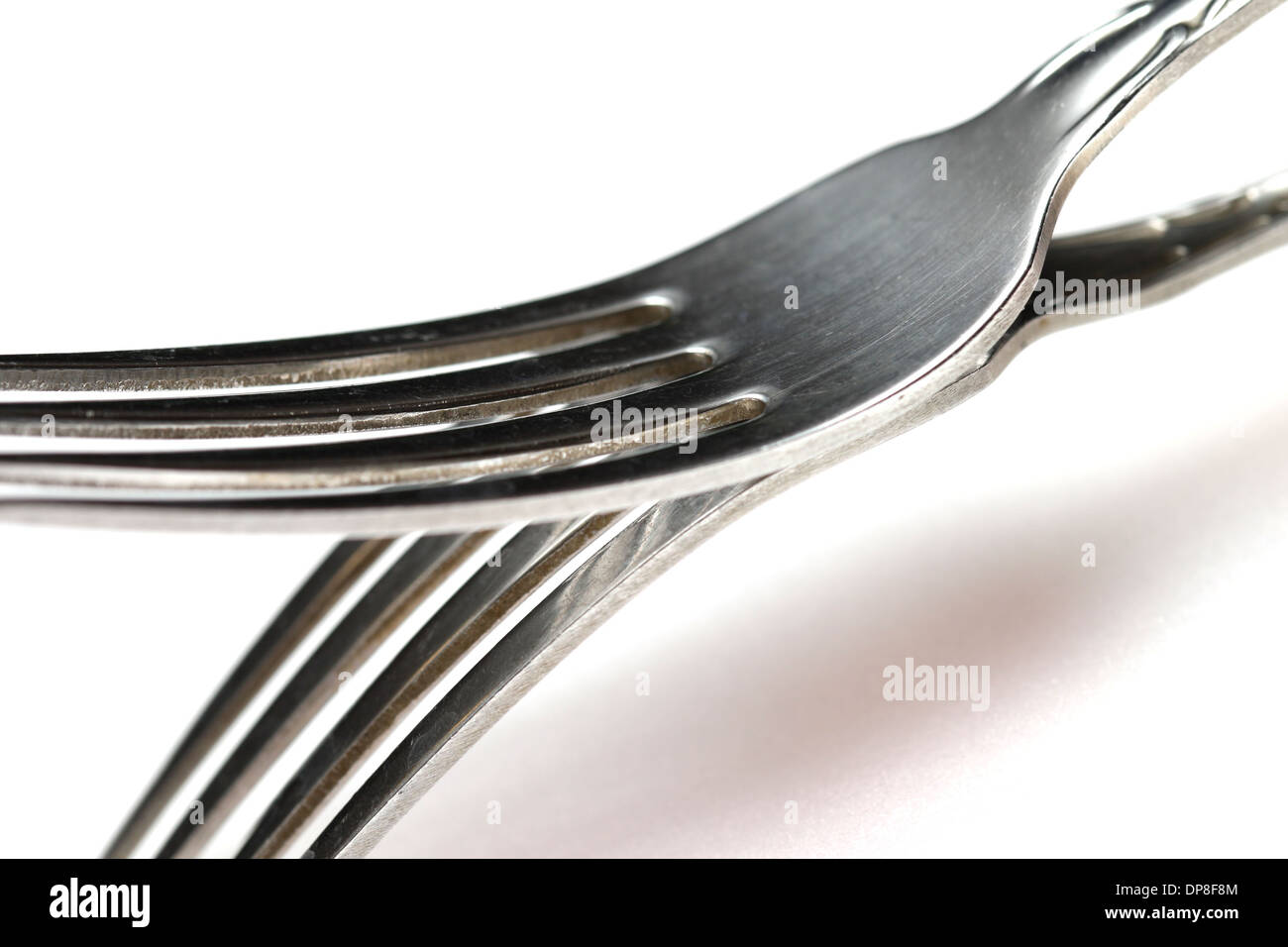 Two forks on a white background Stock Photo - Alamy