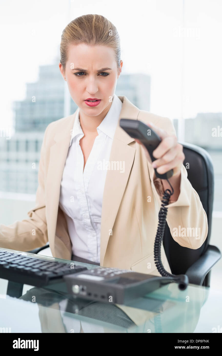 Angry pretty businesswoman hanging up the phone Stock Photo - Alamy