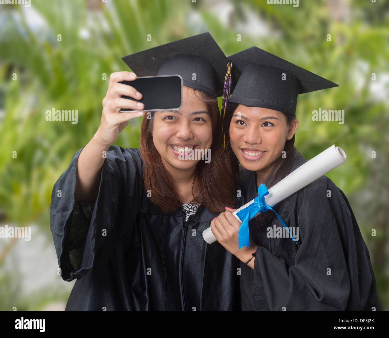 two graduates taking a photo with smart phone Stock Photo - Alamy