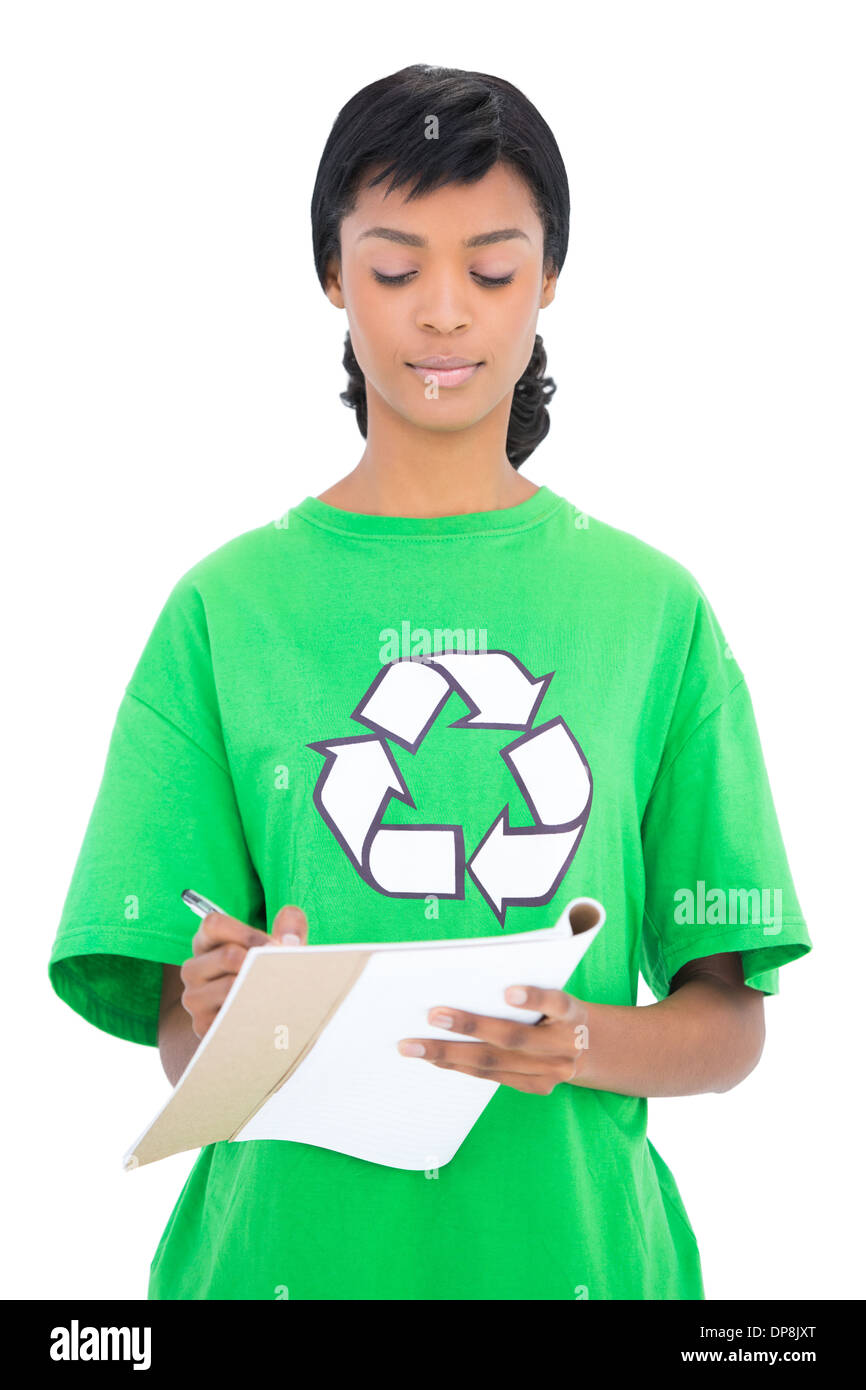 Concentrated black haired ecologist writing on a notebook Stock Photo ...