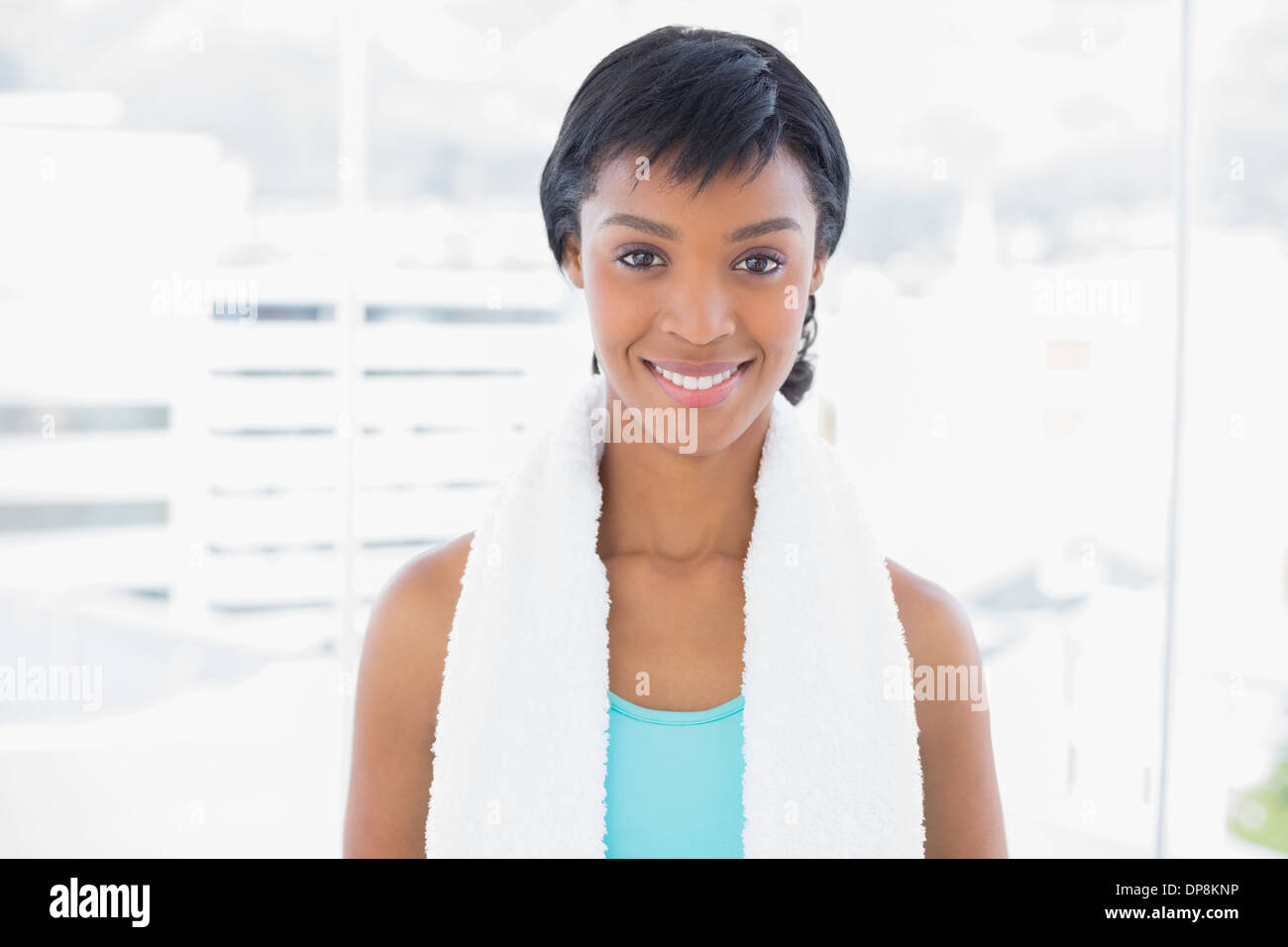 Content black haired woman wearing a towel around her neck Stock Photo ...