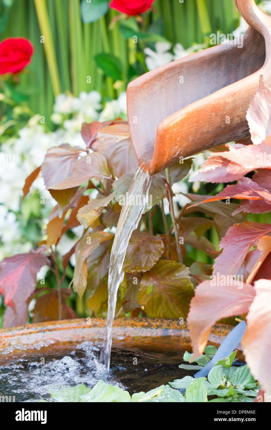 Close up of clay water feature with pond Stock Photo - Alamy