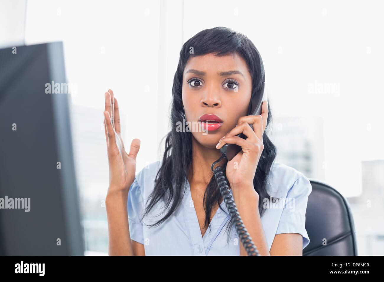 Shocked businesswoman answering the telephone Stock Photo - Alamy