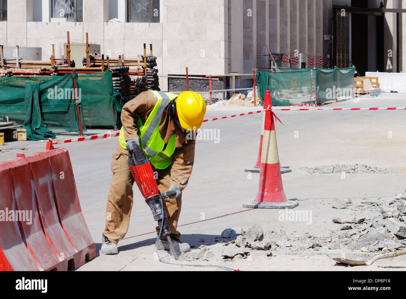 A steel fixer carefully tying reinforced steel bars in position in ...