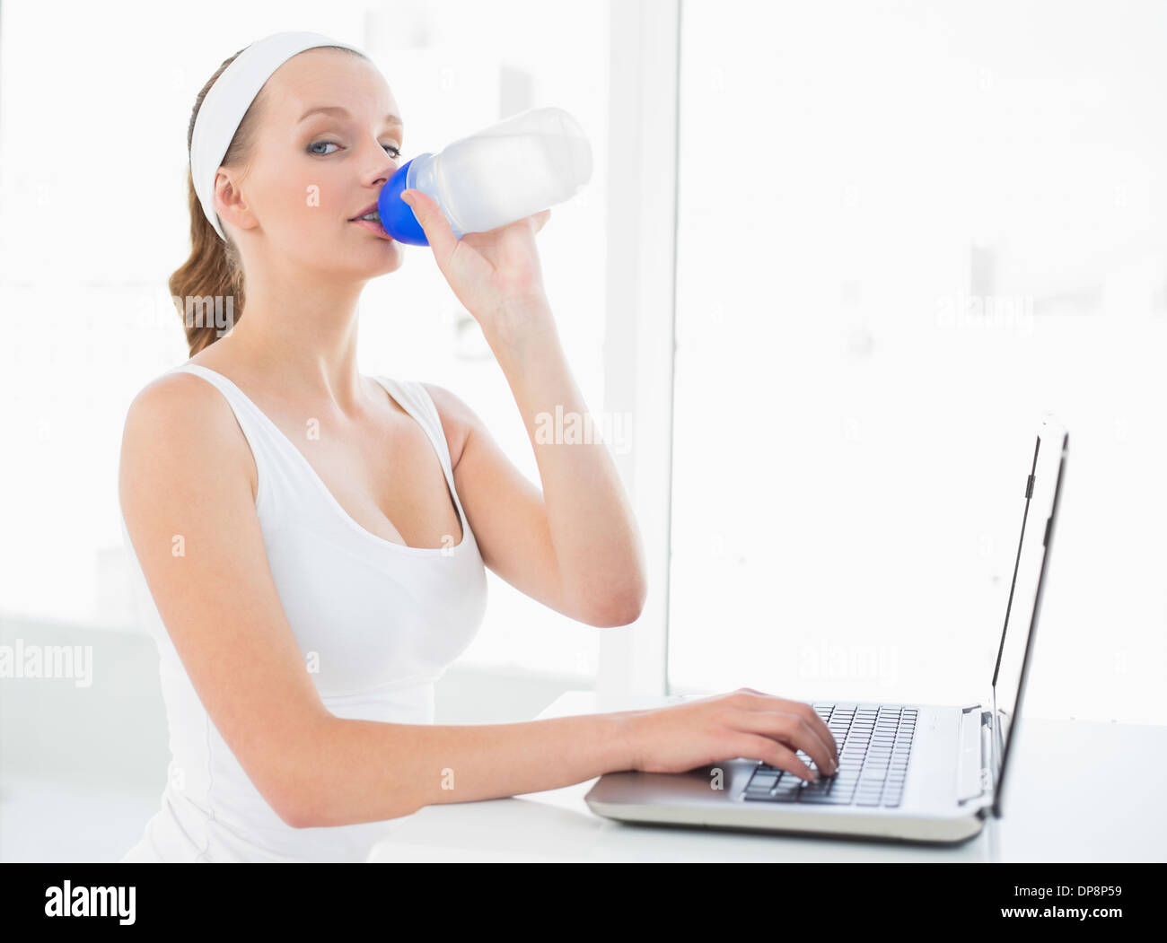 Serious pretty sportswoman drinking water Stock Photo - Alamy