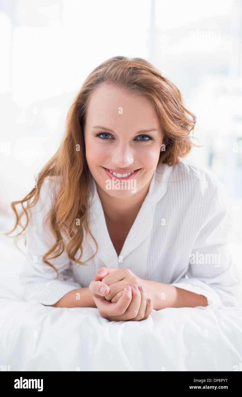 Content pretty woman lying on her bed Stock Photo - Alamy