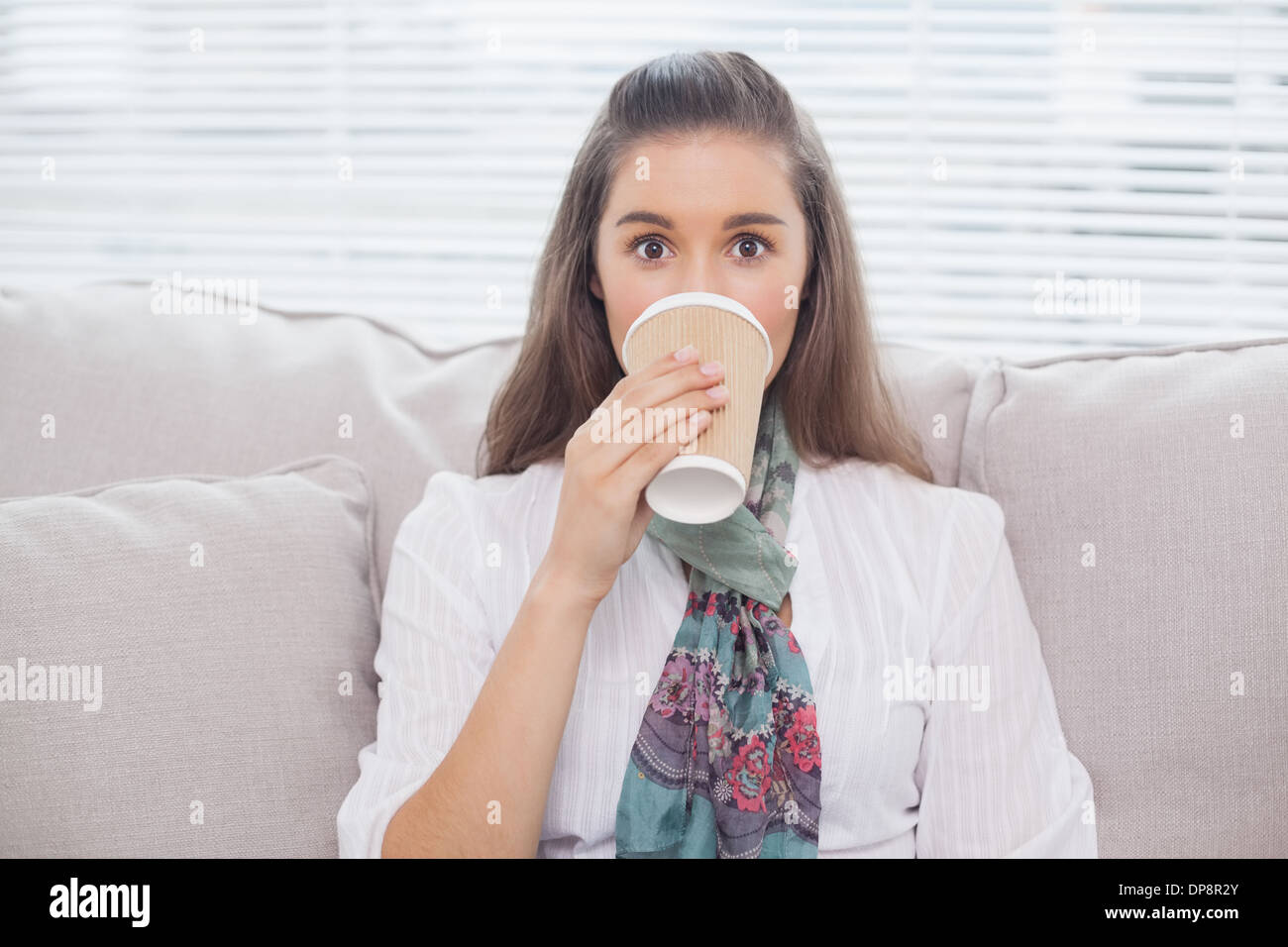 Smiling pretty model drinking coffee Stock Photo - Alamy