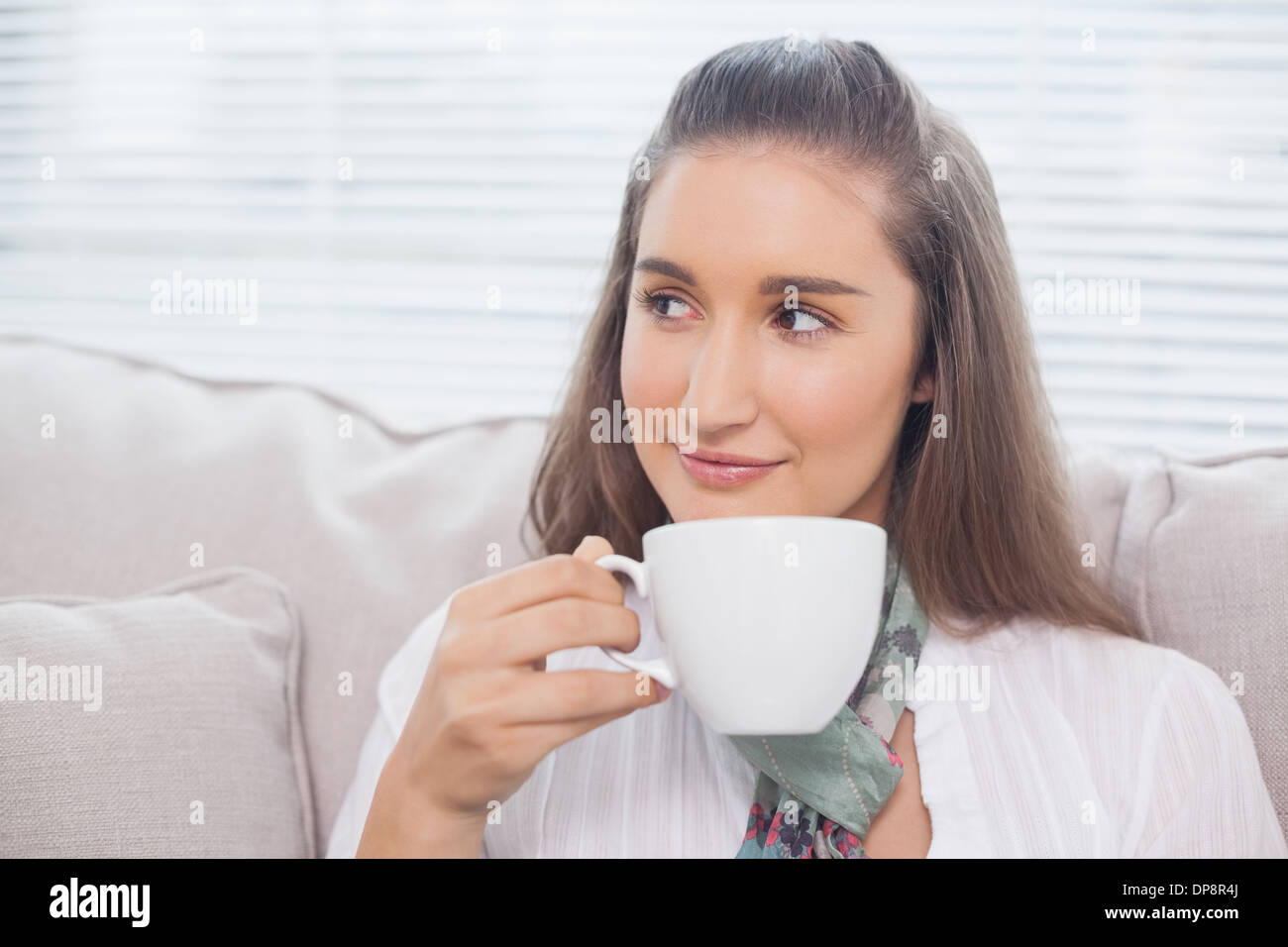 Peaceful cute model holding coffee Stock Photo - Alamy