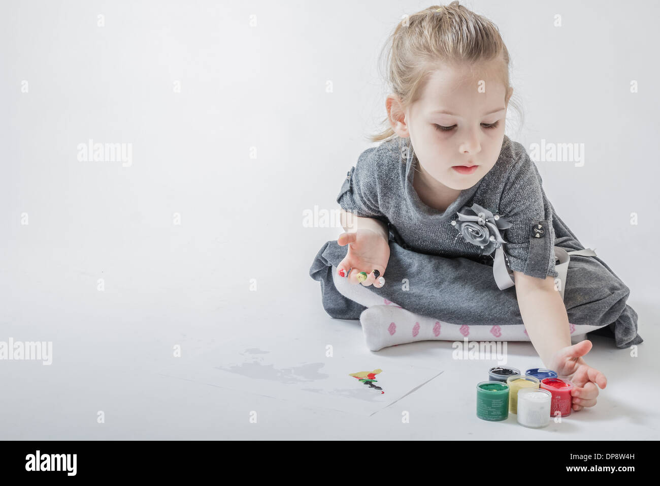 Little cute girl painting the world map with finger paint Stock Photo ...