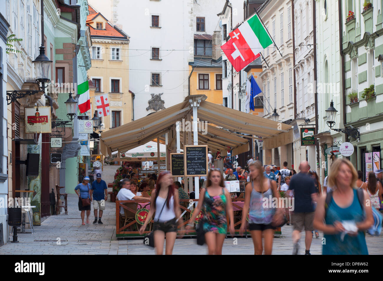 People walking past outdoor cafes along Michalska Street, Bratislava ...