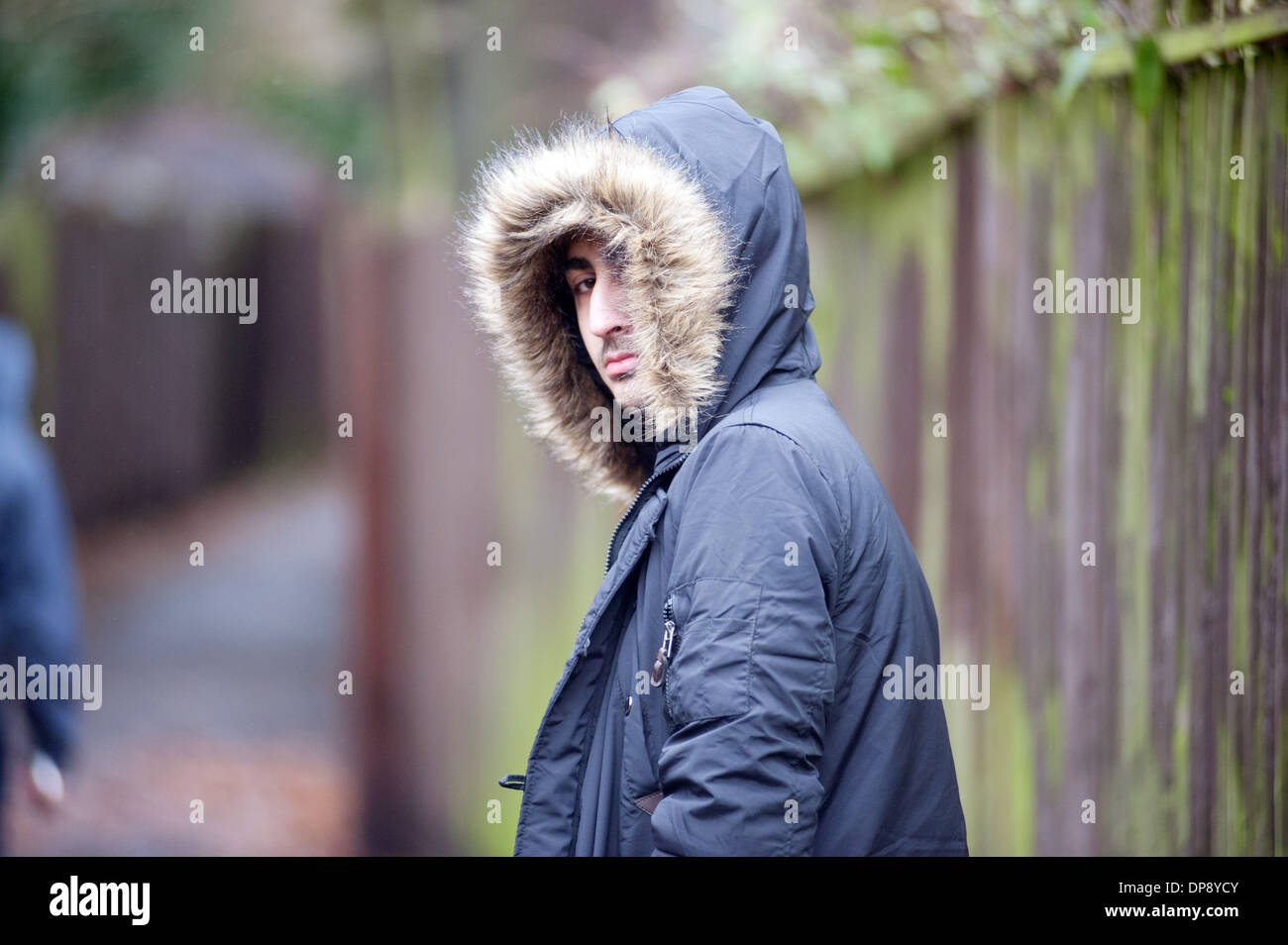 A Teenage boy in a hoodie looking menacing Stock Photo - Alamy