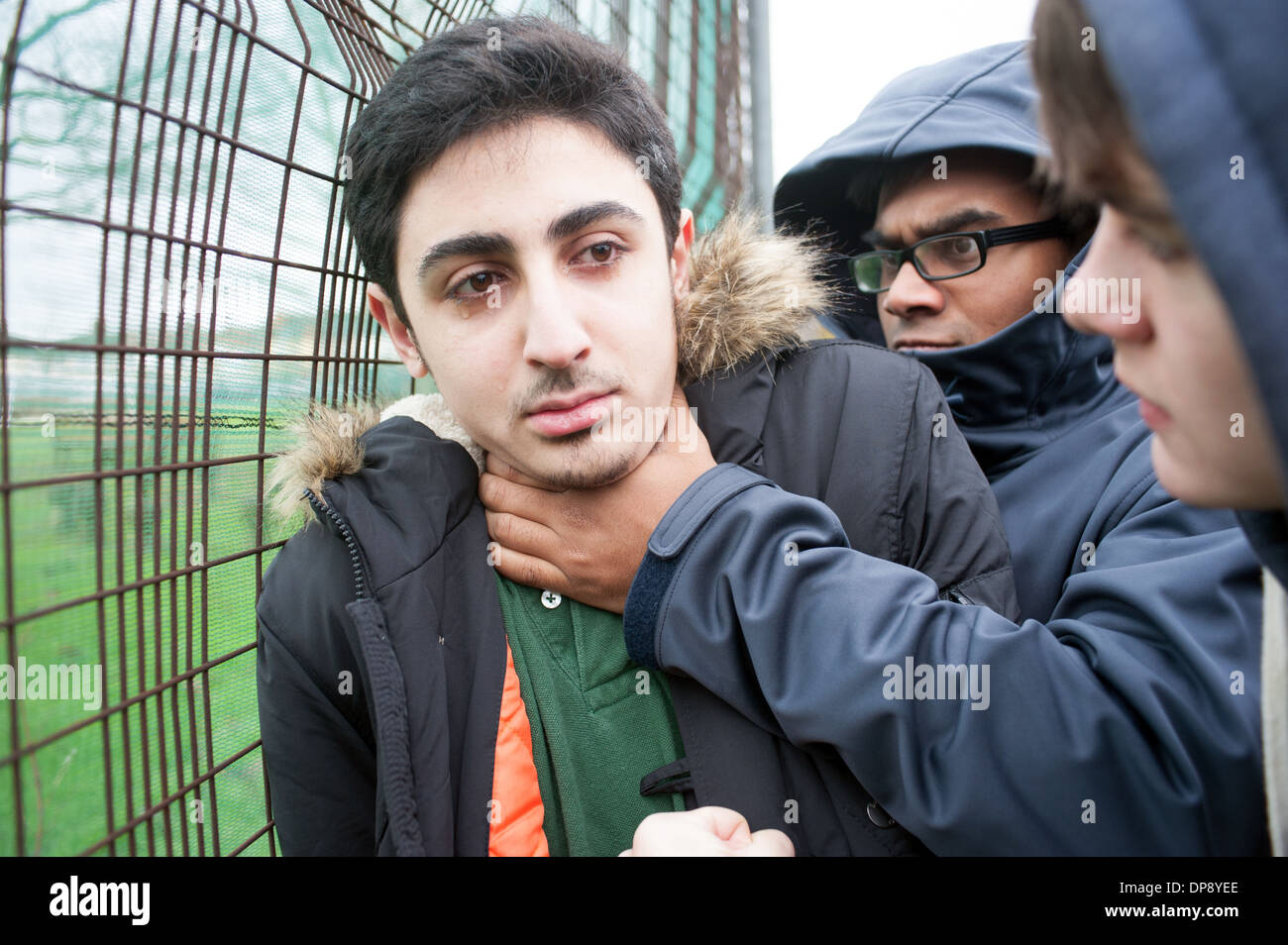 A young man being bullied by a group of teenage boys Stock Photo ...